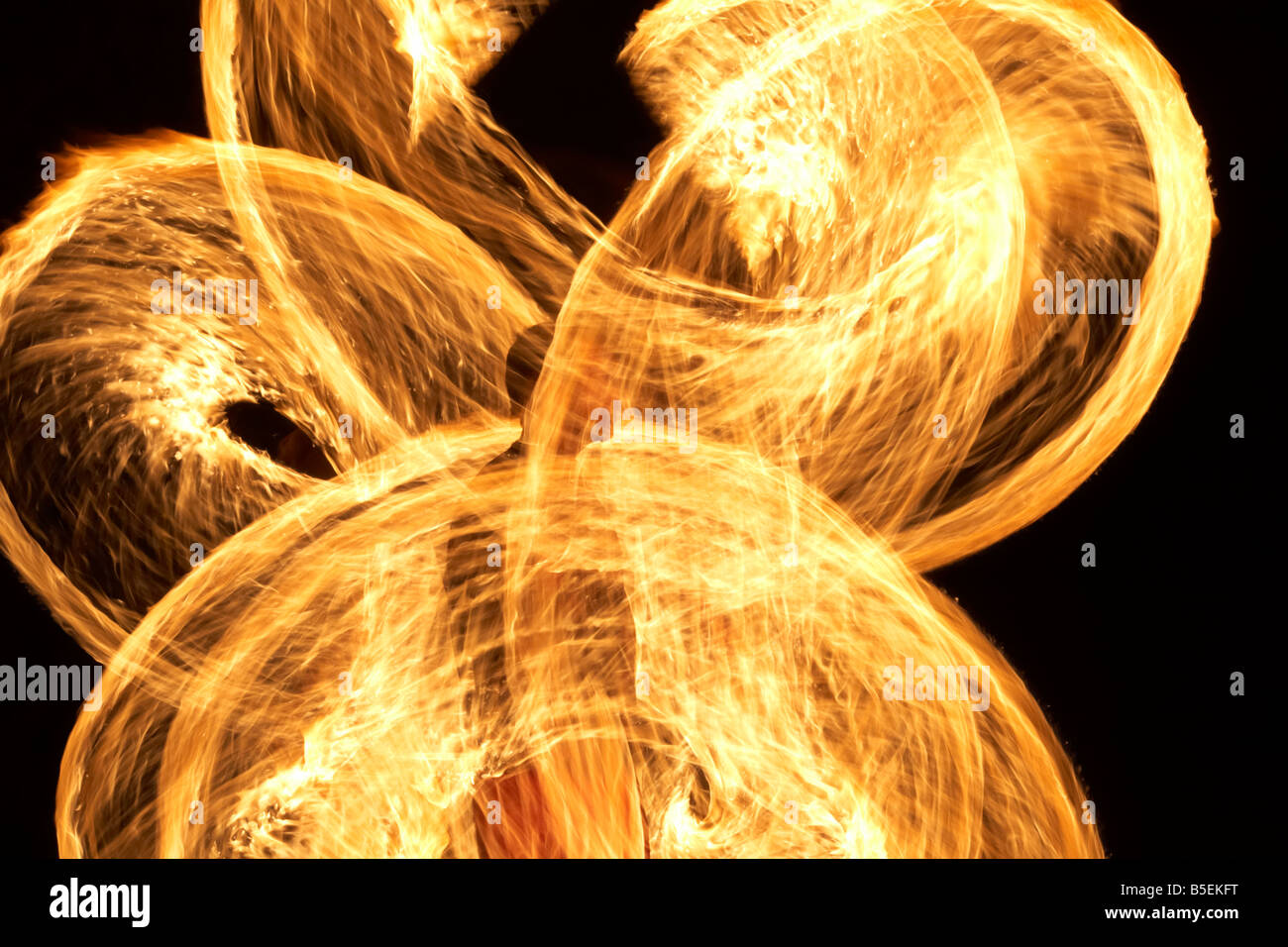 firepoise man performance artist displaying fire patterns with poi ...