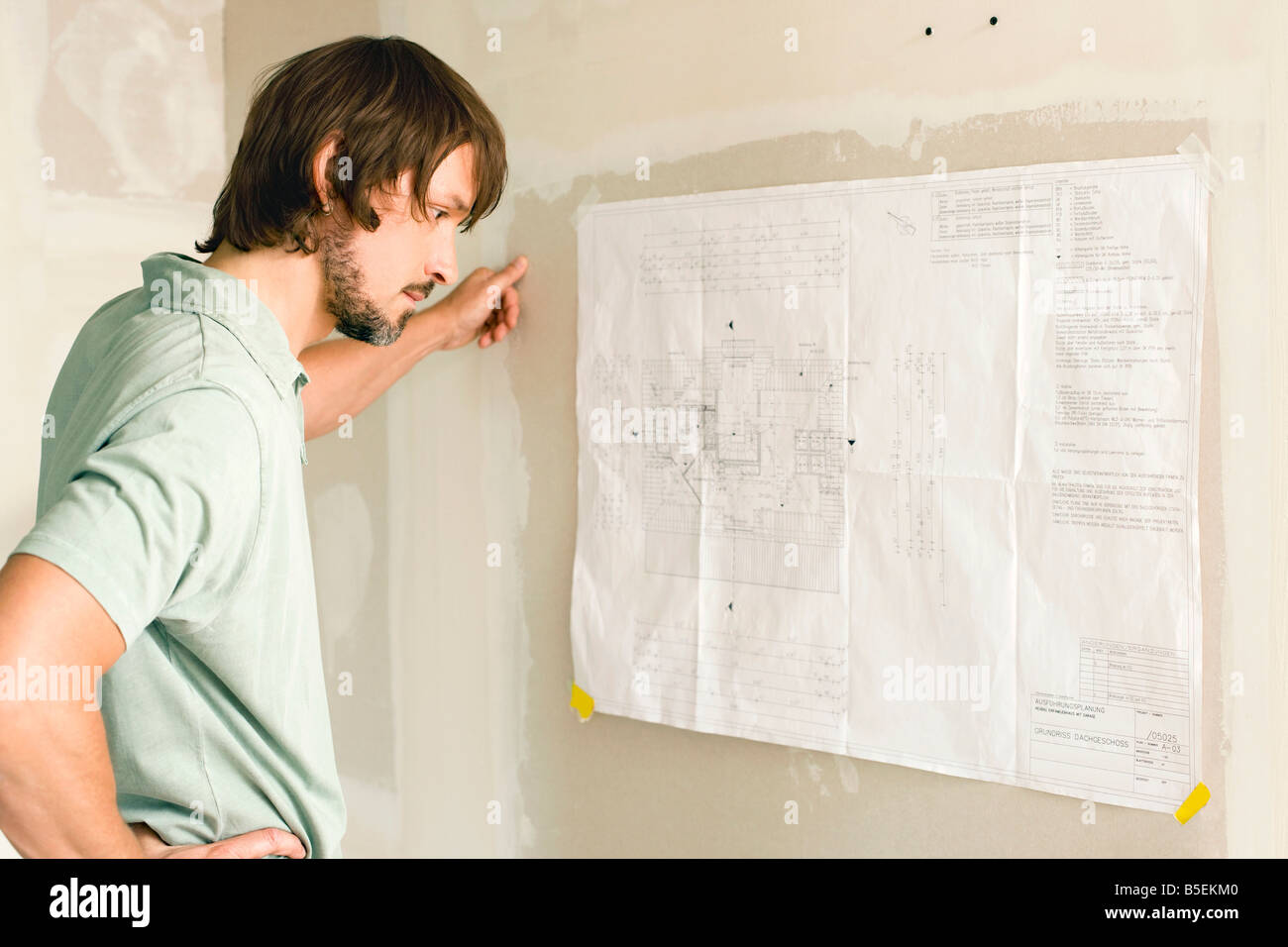 Young man studying construction plan Stock Photo - Alamy Young man studying construction plan Stock Photo - Alamy