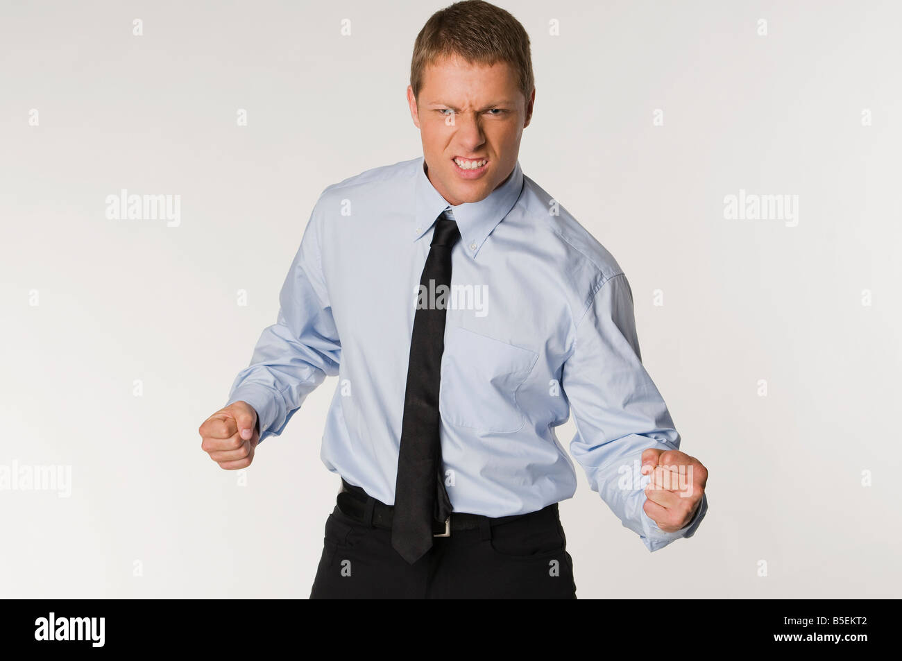 Determined man clenching fist Cut Out Stock Images & Pictures - Alamy