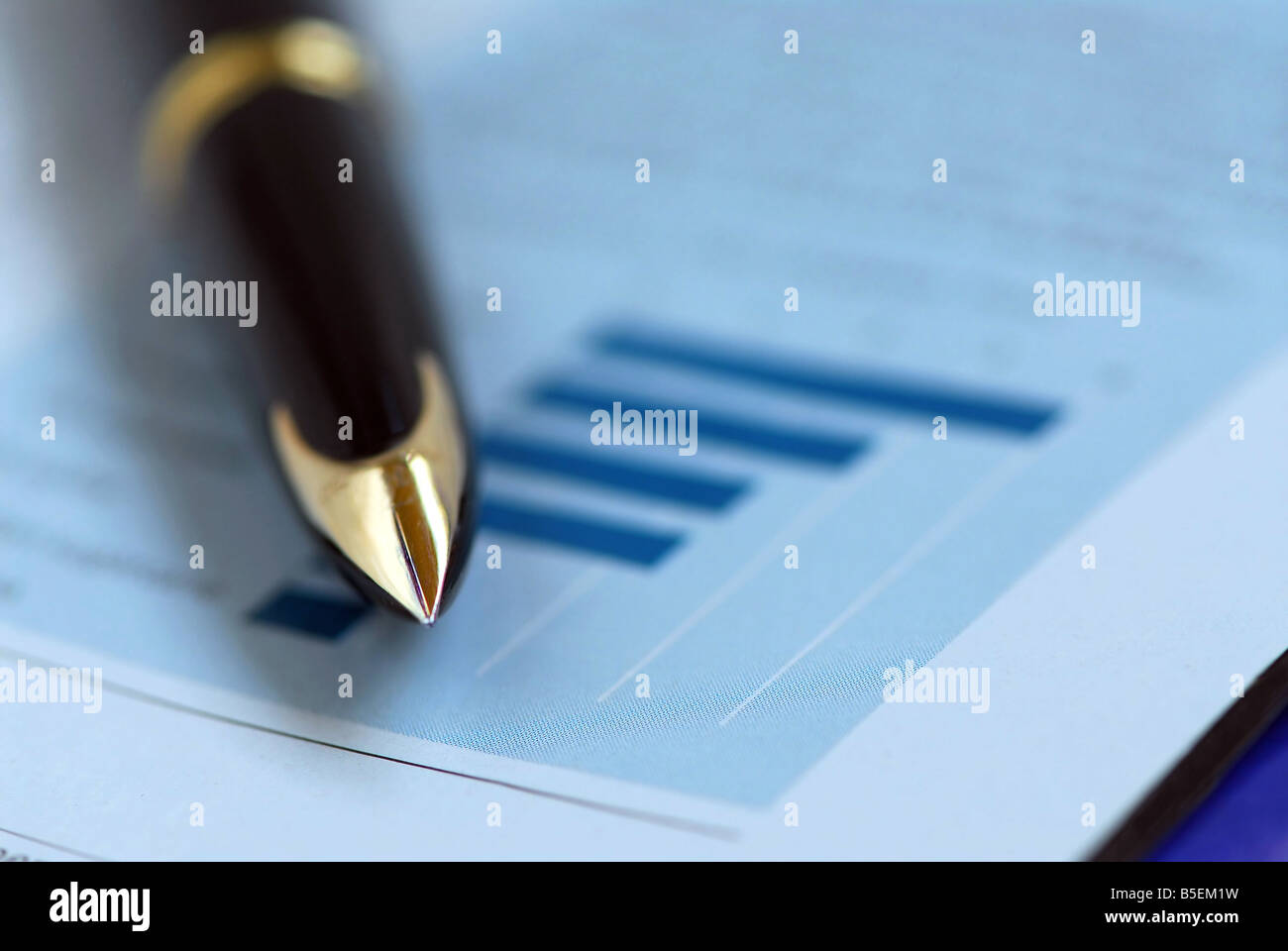 Golden pen on financial chart Stock Photo - Alamy