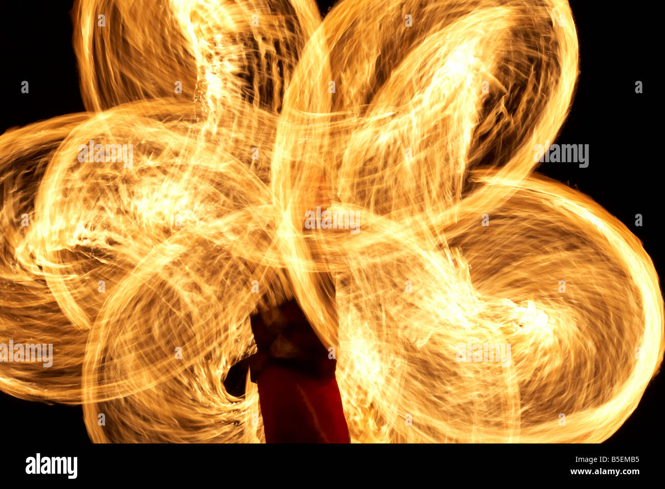 firepoise man performance artist displaying fire patterns with poi ...