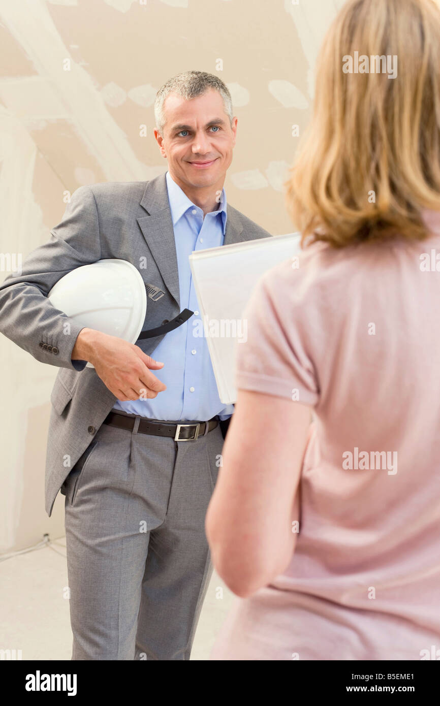 Young woman and architect having a conversation Stock Photo - Alamy