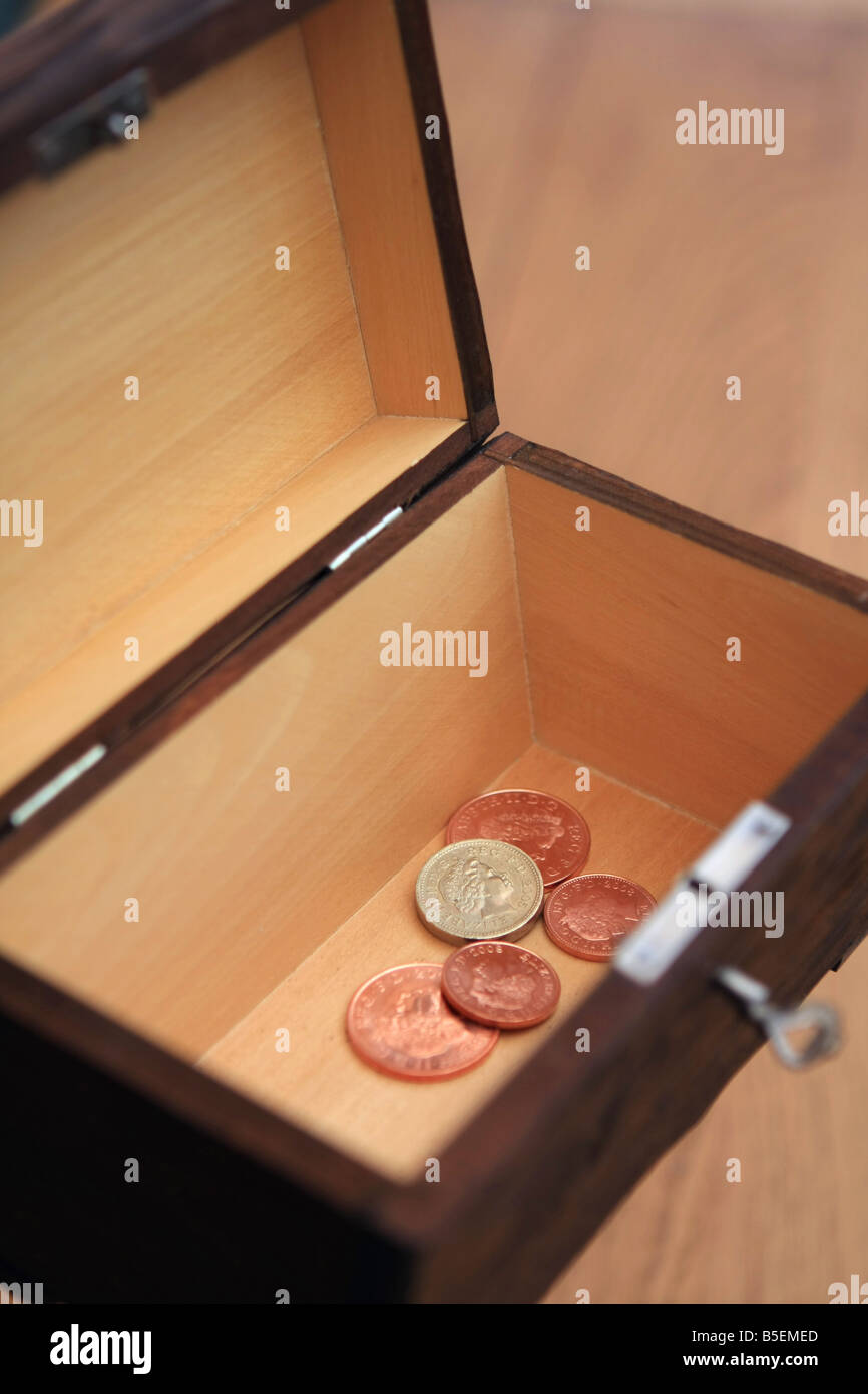 some coins in an open chest Stock Photo - Alamy