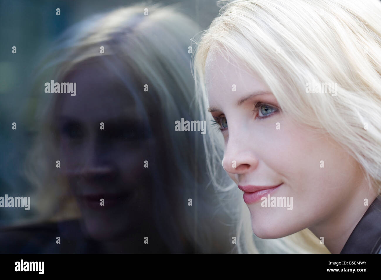 Young woman next to shop window, reflection, portrait, close-up Stock ...