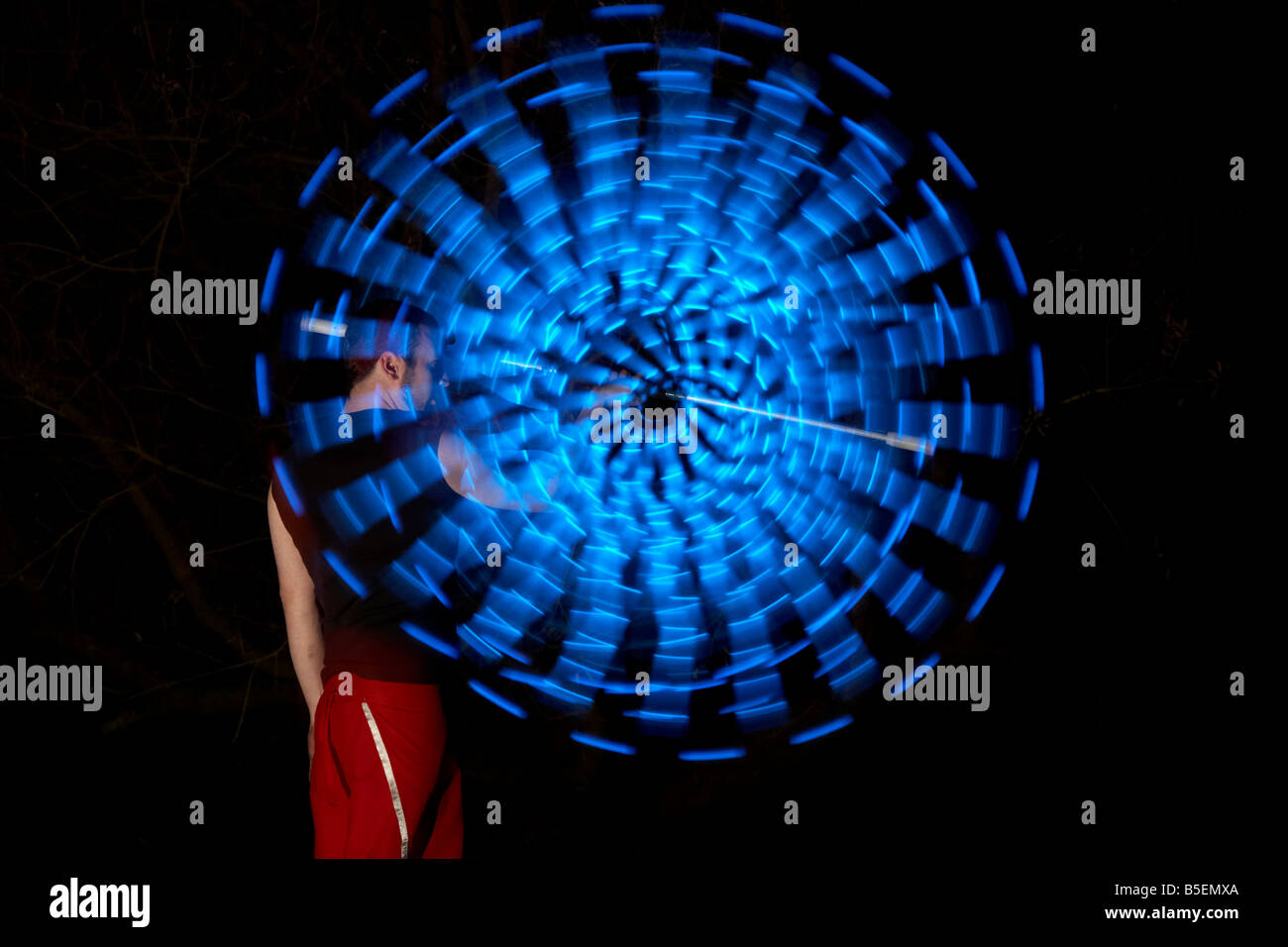 man juggling LED lightstick playing with lights Stock Photo - Alamy