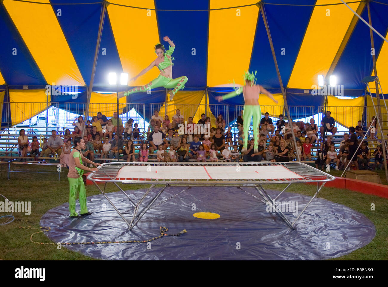 Circus performers on a trampoline Stock Photo - Alamy