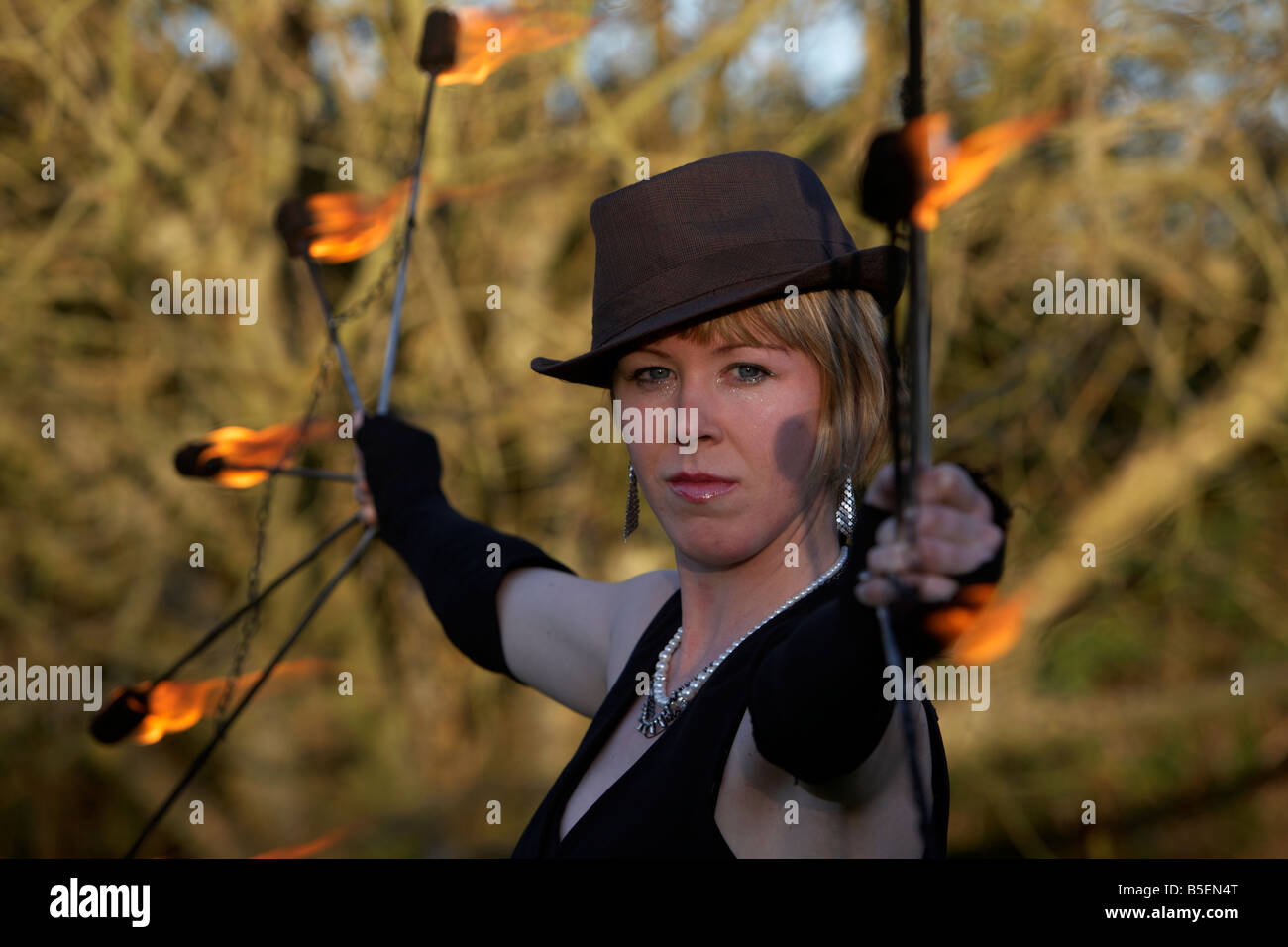 firepoise female fire dance performance artist wearing hat holding fire ...