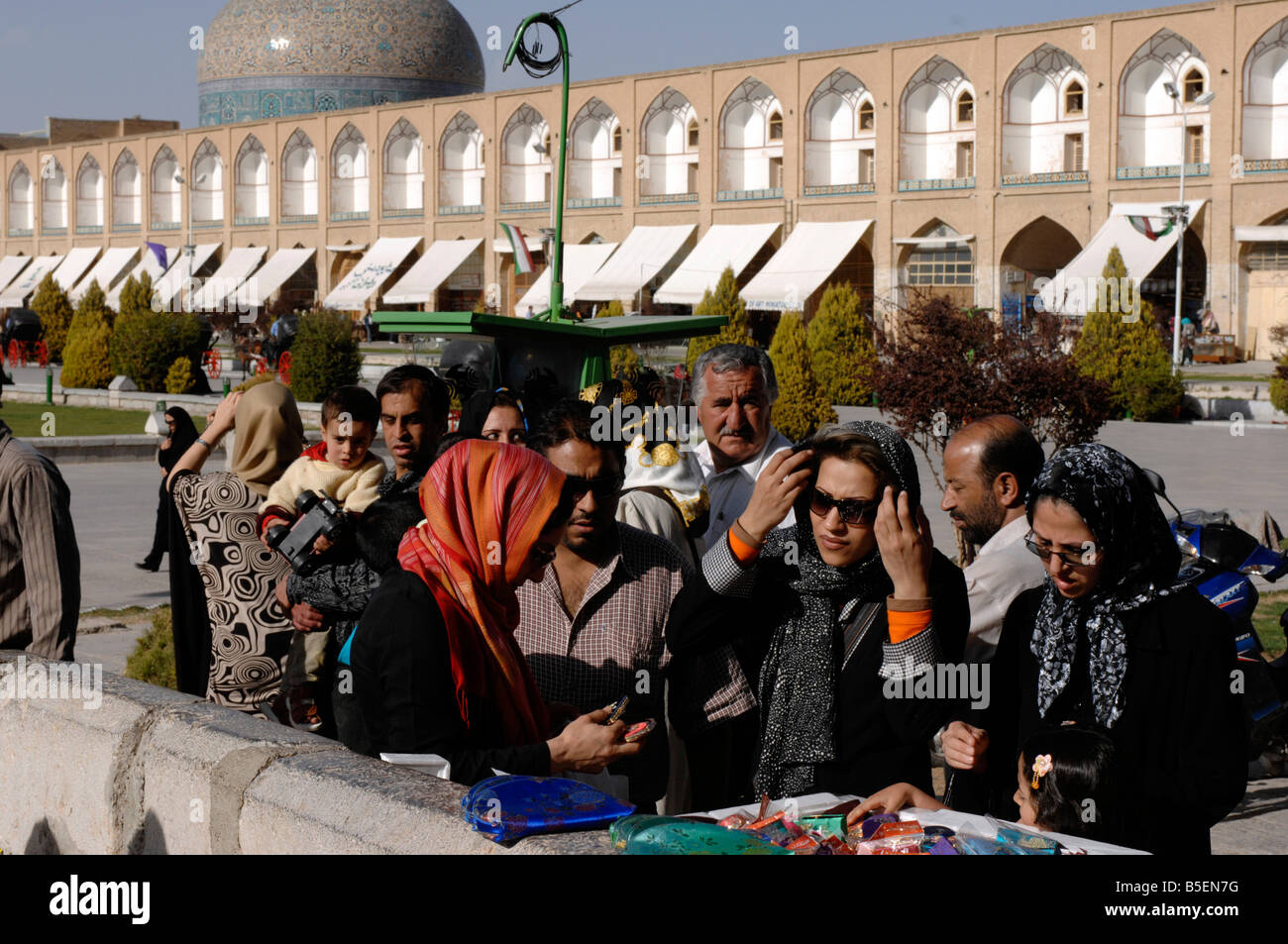 Iranian tourists survey a stall in the historic Imam Square Stock Photo ...