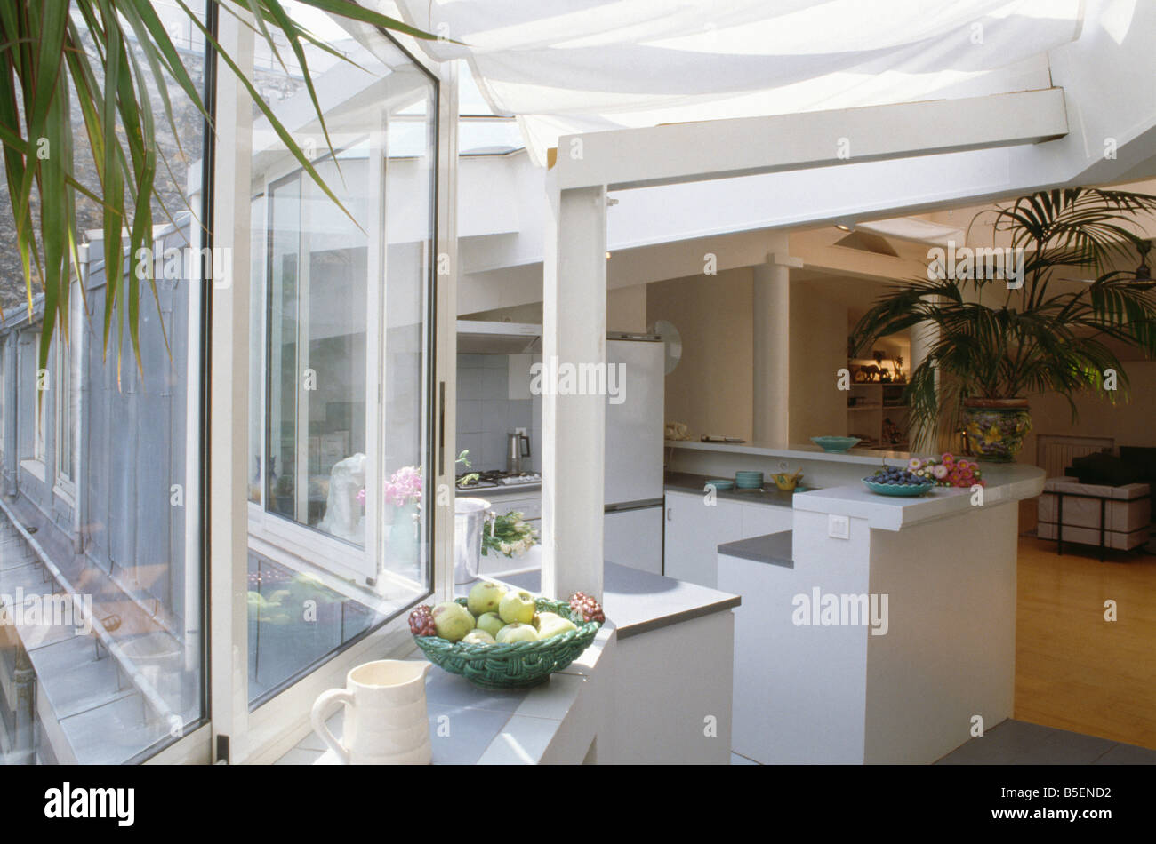 Double-glazed window in openplan white kitchen Stock Photo - Alamy