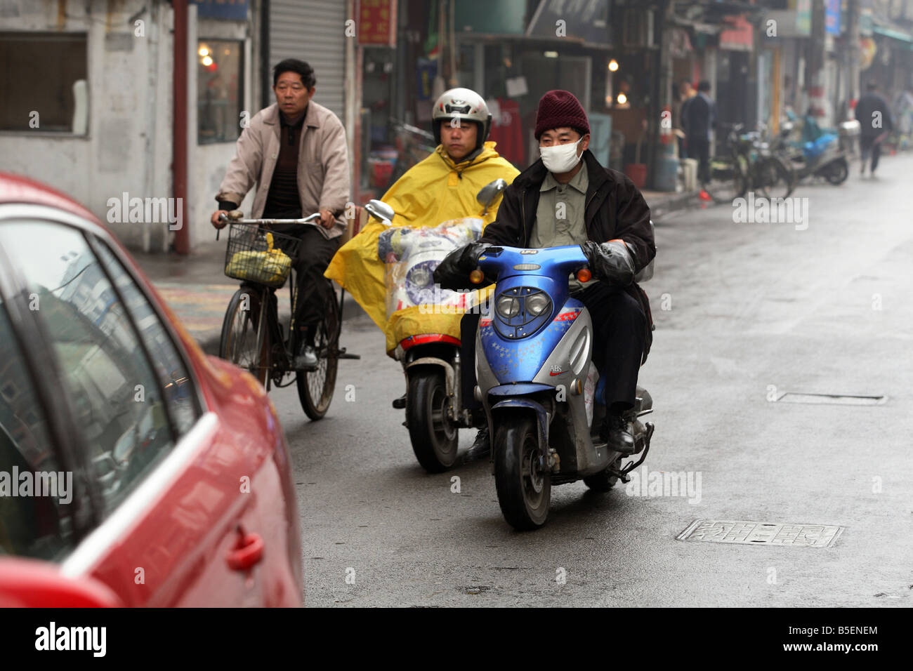 People on scooters driving trough Shanghai, China Stock Photo - Alamy