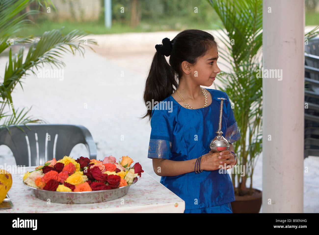 a young Indian child is waiting to welcome guests at an indian wedding ...