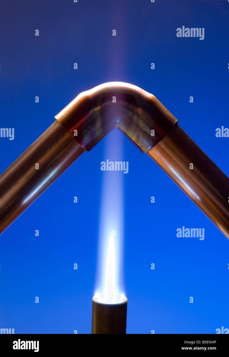 Copper elbow join heated up for soldering Stock Photo - Alamy