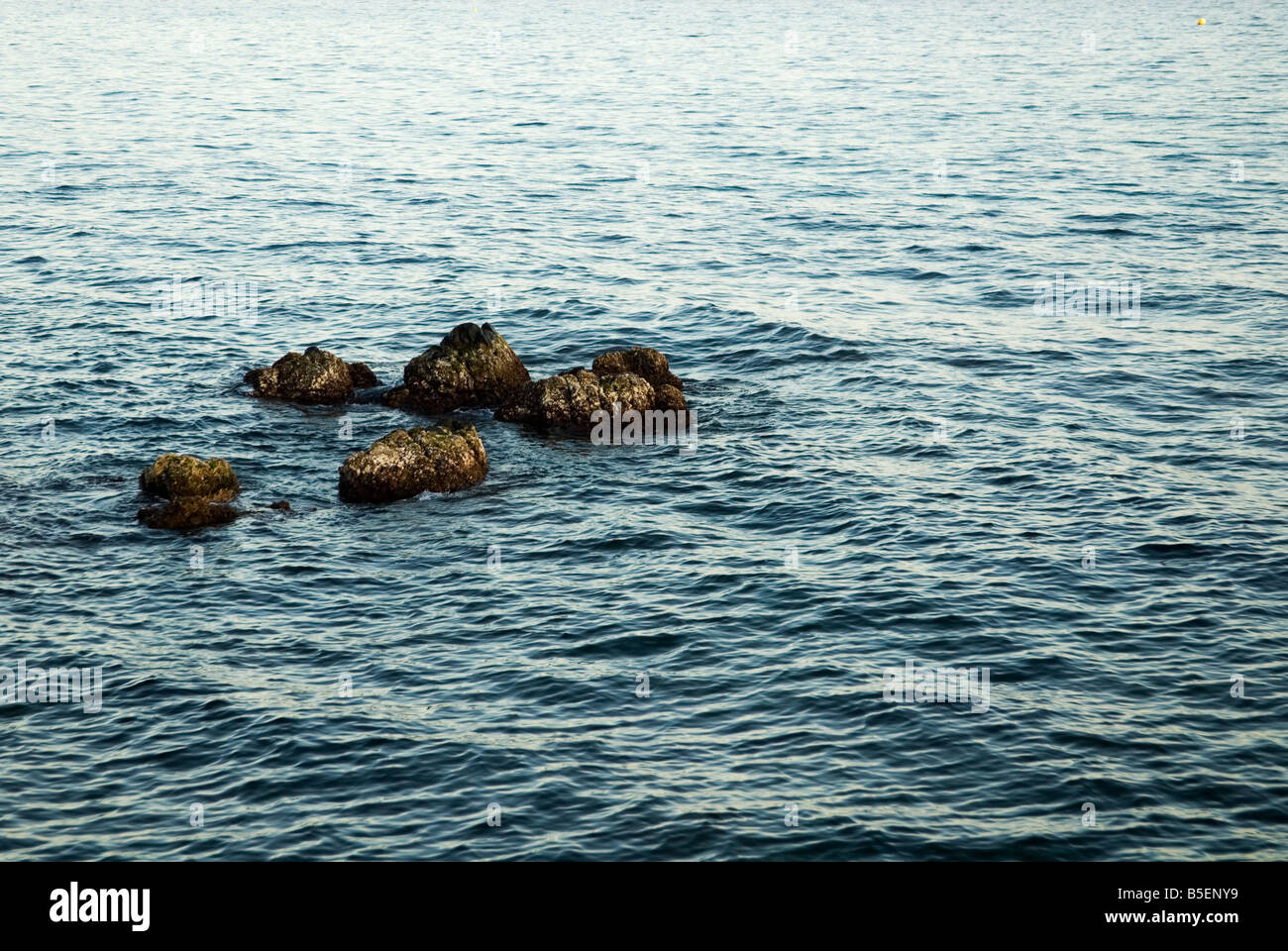 five small rocks break the water's surface Stock Photo - Alamy