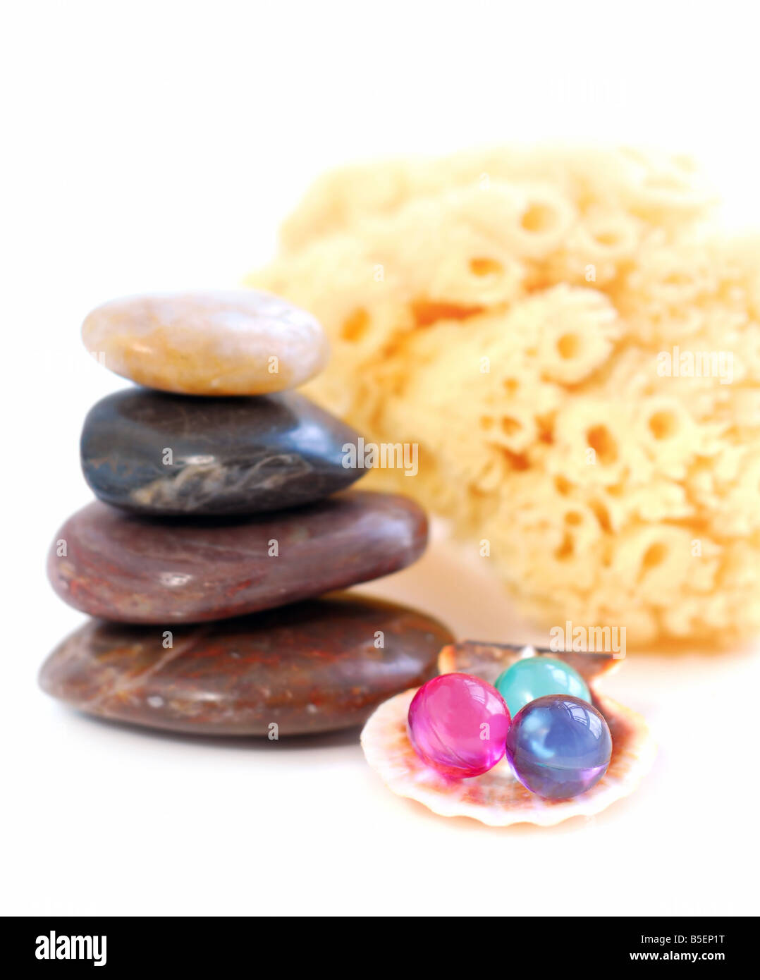 Stack of balanced stones with bath beads isolated on white background ...
