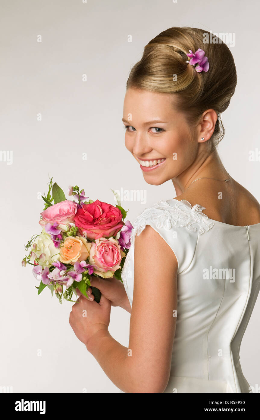 Young bride holding bridal bouquet Stock Photo - Alamy