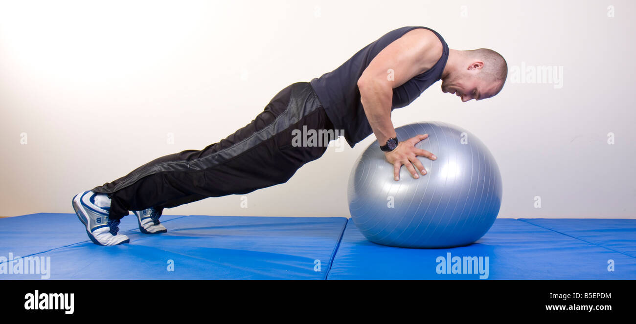 young man doing push-up on Swiss ball Stock Photo - Alamy