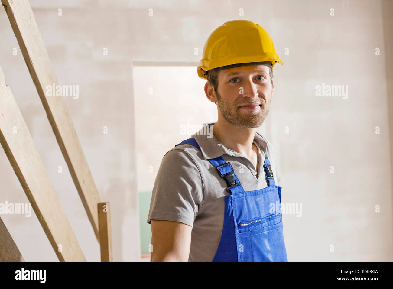 Construction worker at construction site, smiling, portrait Stock Photo ...