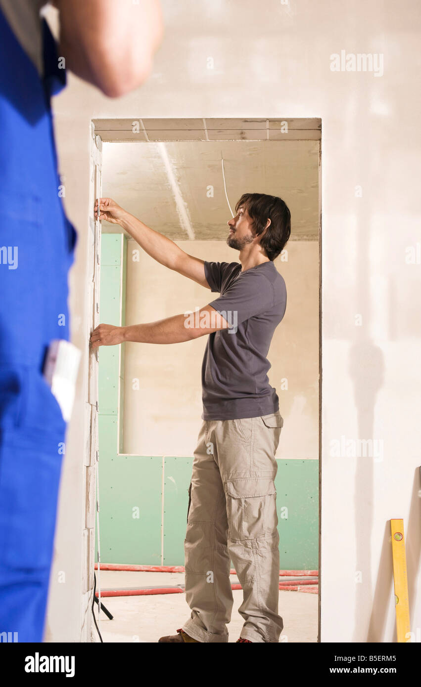 Man measuring door with folding rule Stock Photo - Alamy