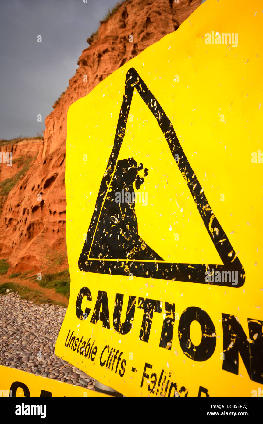 Bright yellow falling rocks sign warning of dangerous fragile sandstone ...