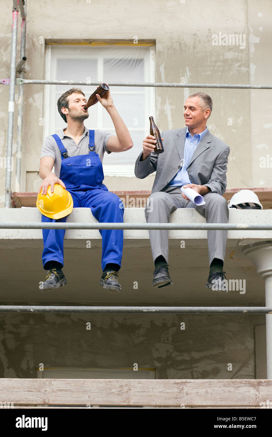 Architect and construction worker on site, taking a break Stock Photo ...