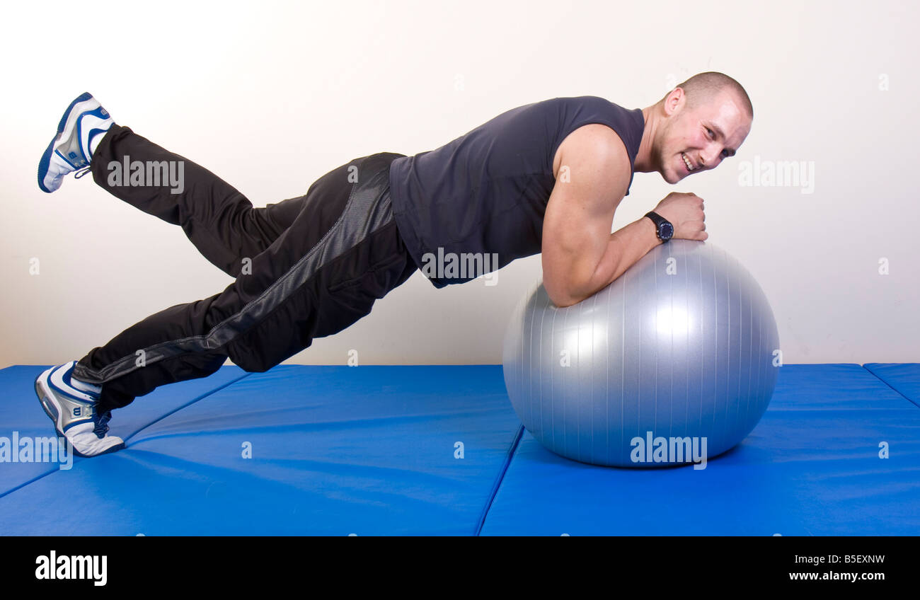 Man swiss ball doing hi-res stock photography and images - Alamy
