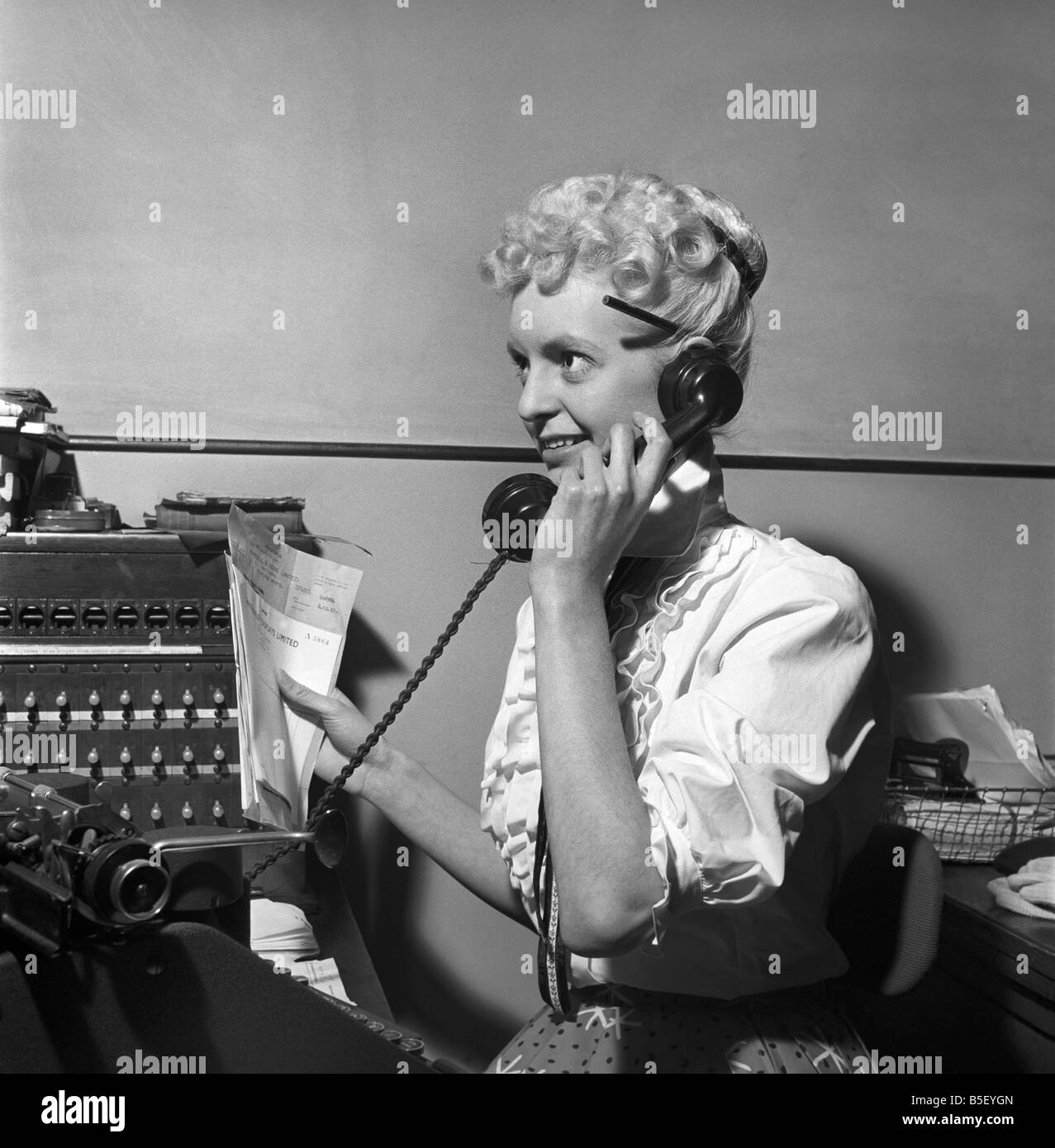 General office scene: Secretary taking notes and answering the phone in ...