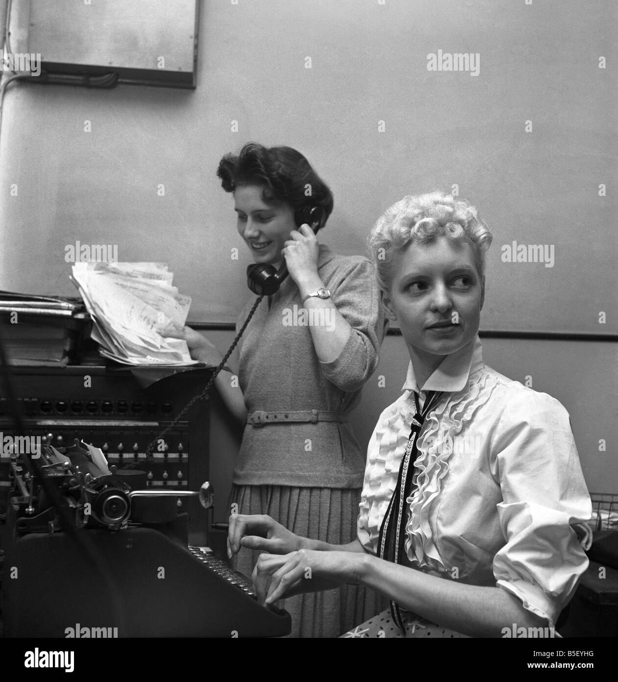 General office scene: Secretary taking notes and answering the phone in ...