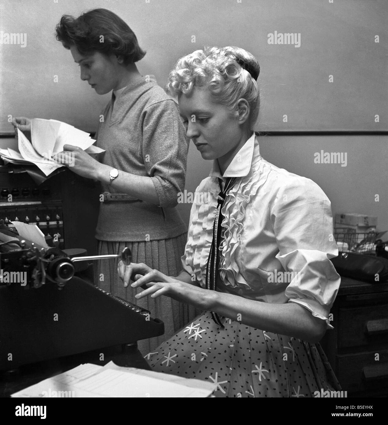 General office scene: Secretary taking notes and answering the phone in ...