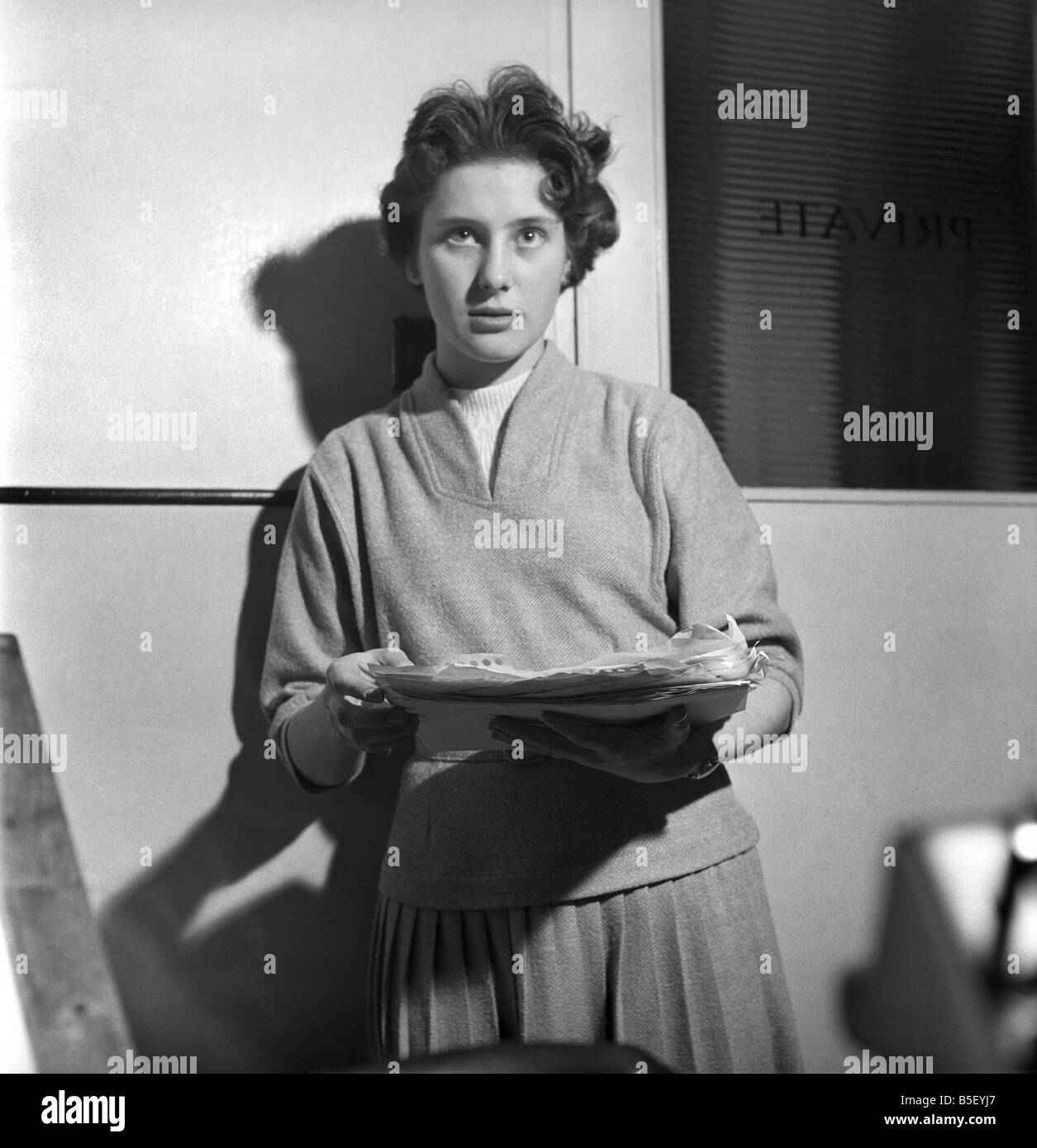 General office scene: Secretary taking notes and answering the phone in ...