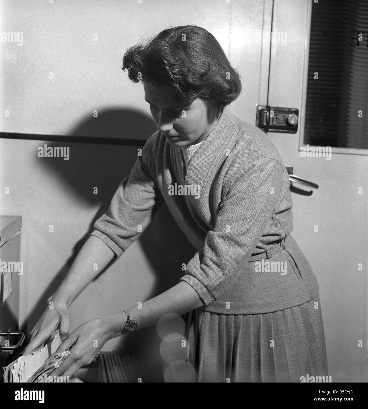 General office scene: Secretary taking notes and answering the phone in ...