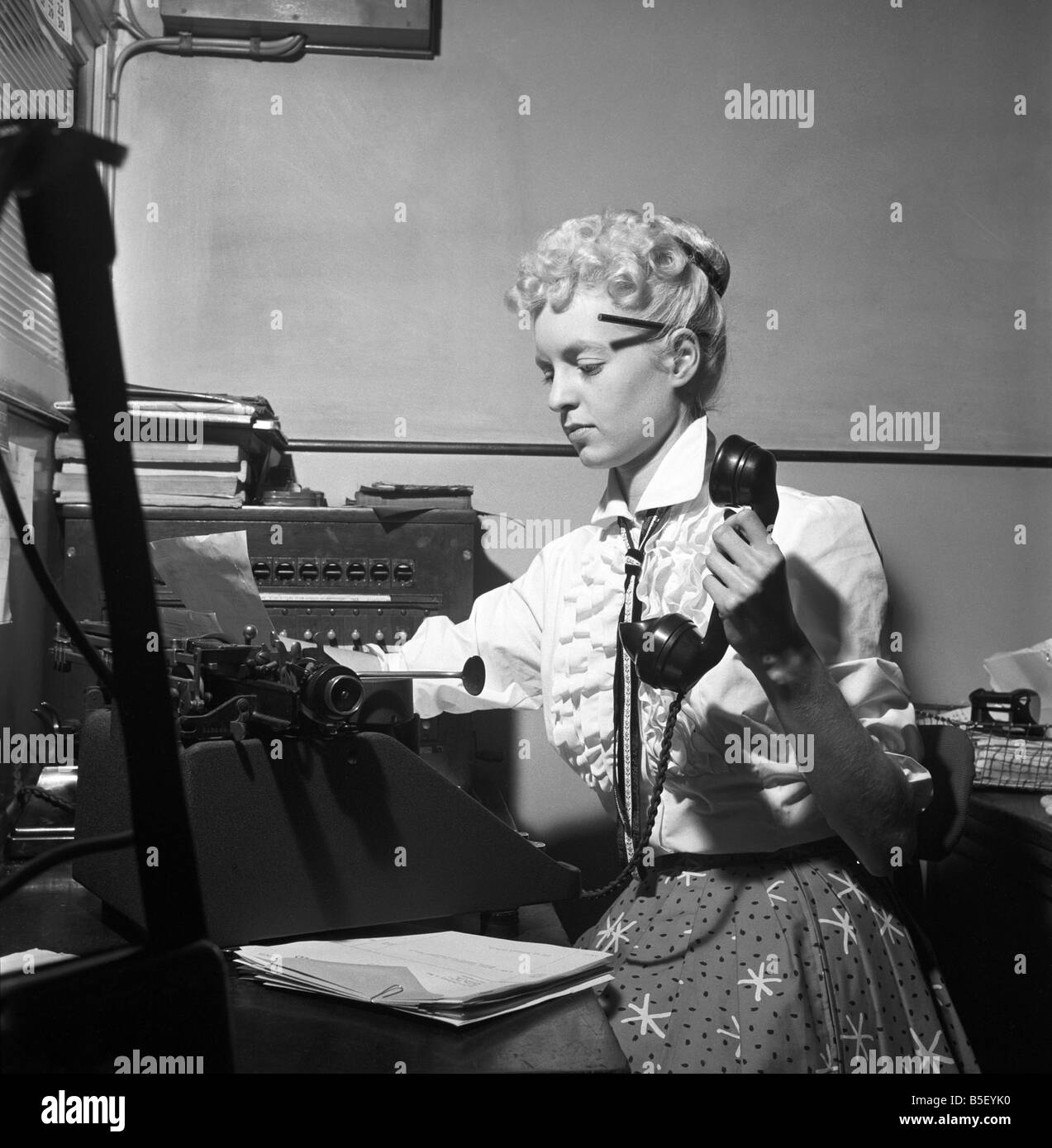 General office scene: Secretary taking notes and answering the phone in ...