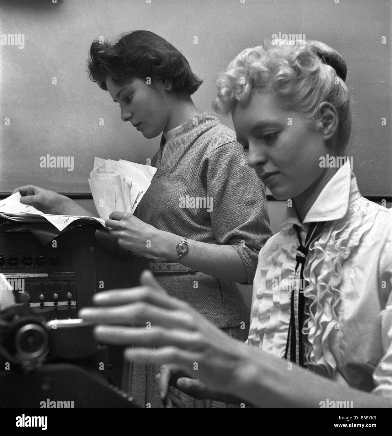 General office scene: Secretary taking notes and answering the phone in ...