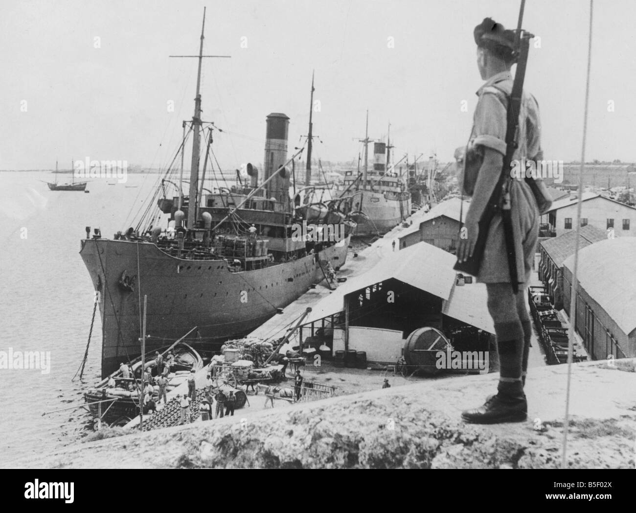 A British soldier on guard duty at one of the docks on the island of ...