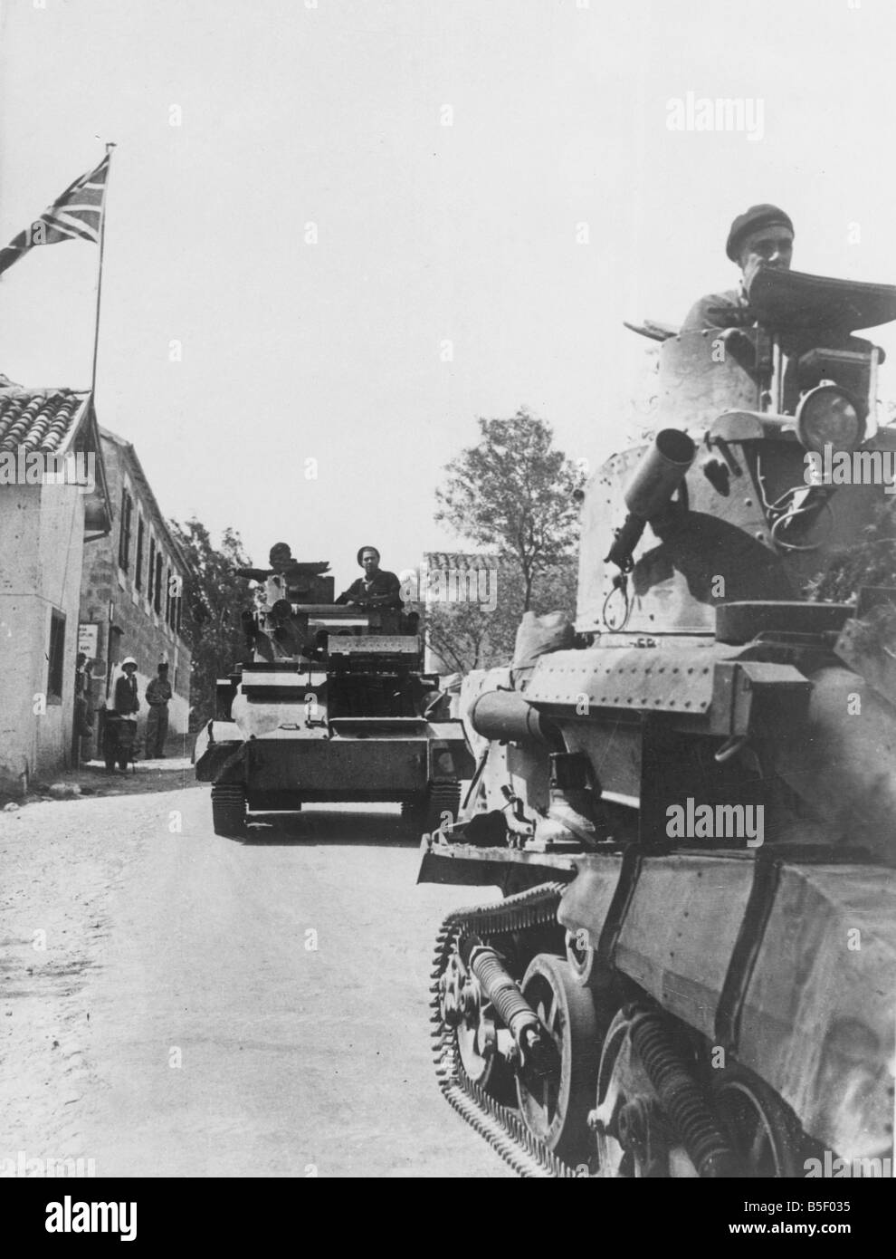 Light tanks rolling through a village on the island of Cyprus during ...
