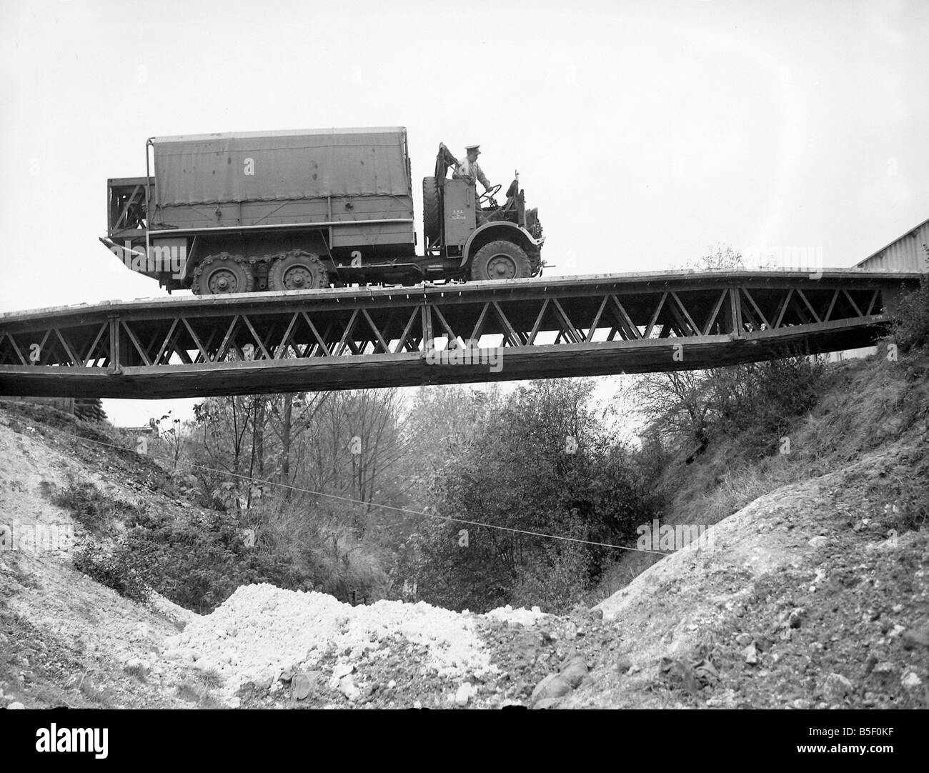 British army soldiers crossing over a bailey bridge in a truck during ...