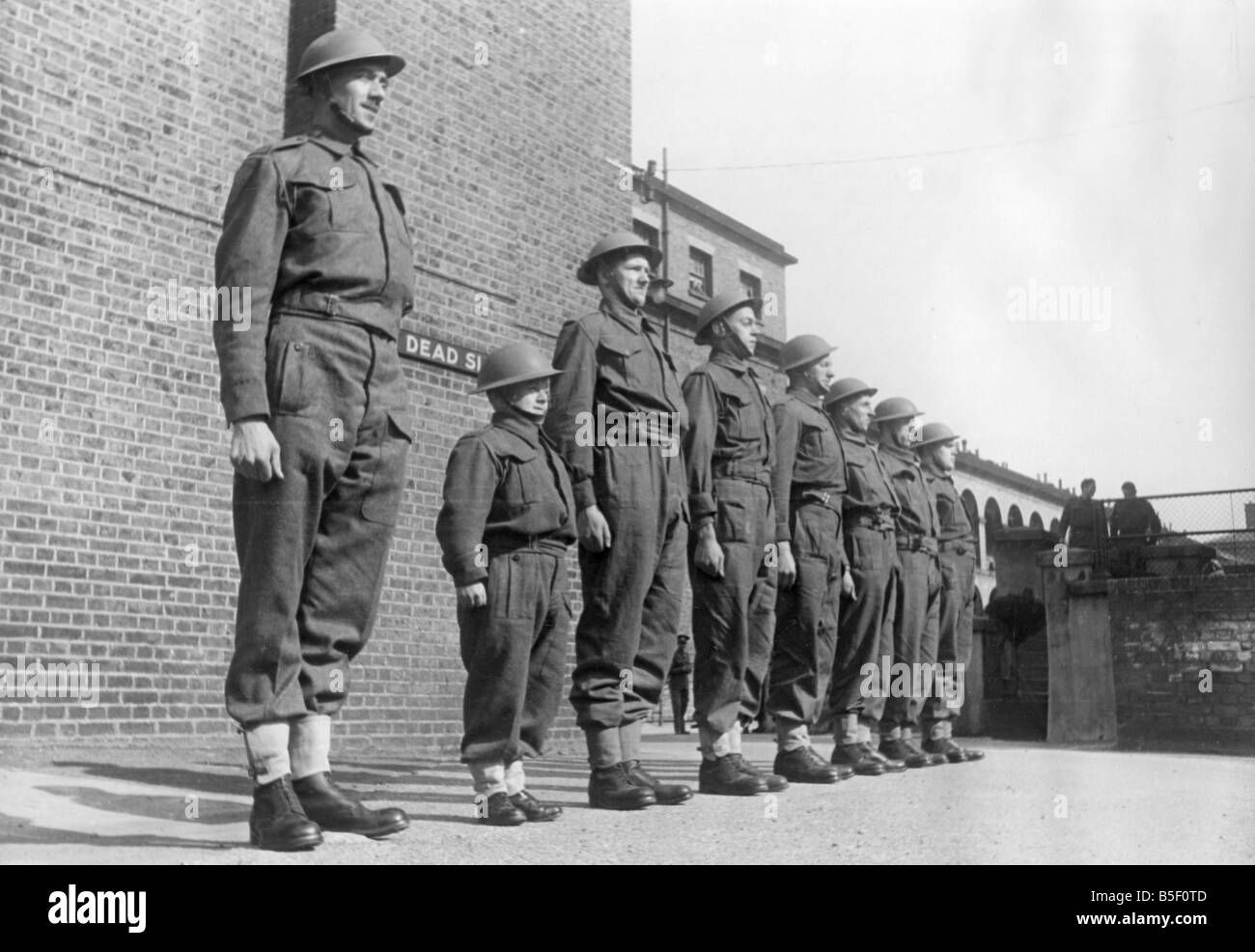 Frank Vincent, the smallest man in the army lines up with the taller ...