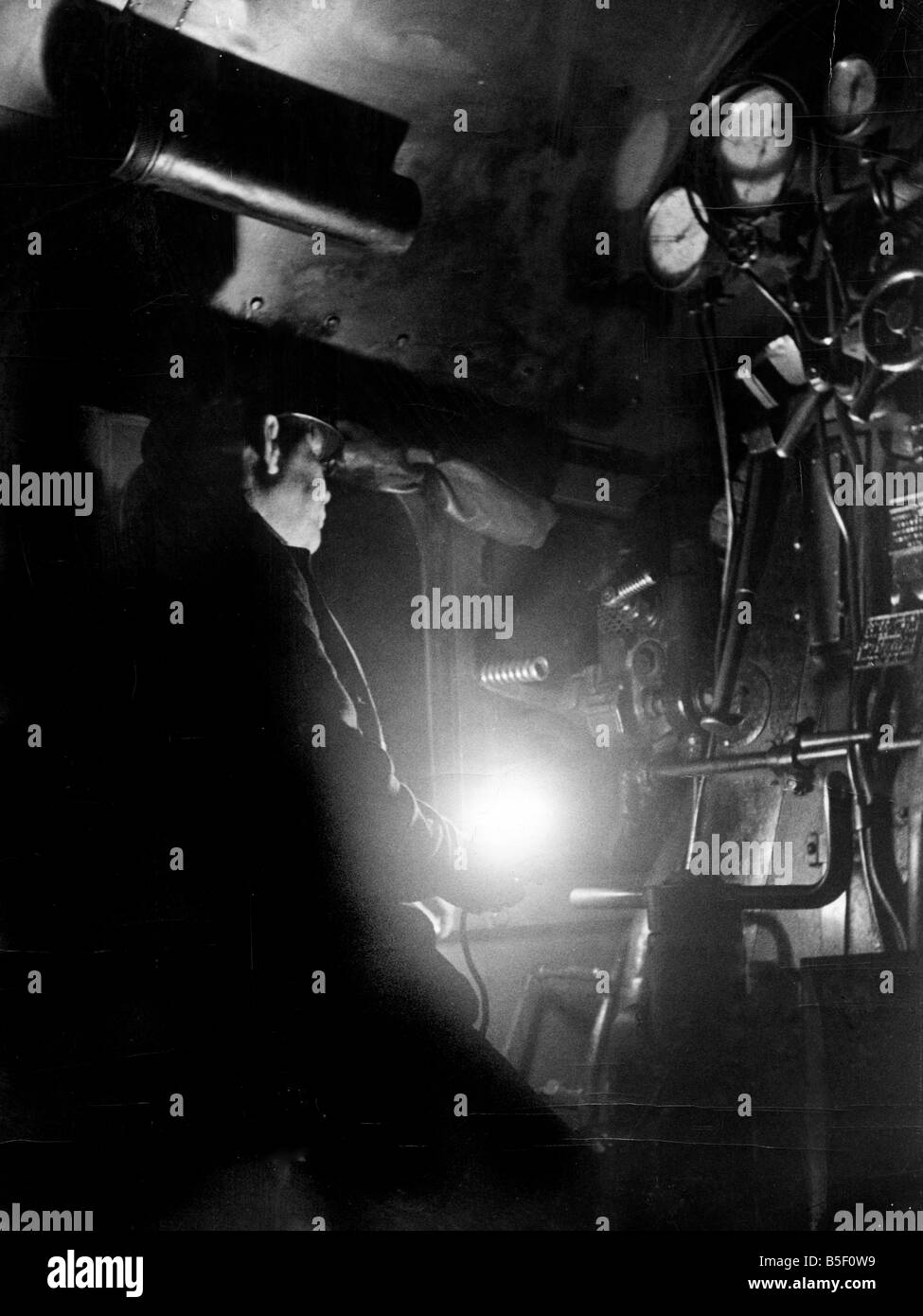 LNER train driver Mr Doughty, checks for his signals while driving his ...