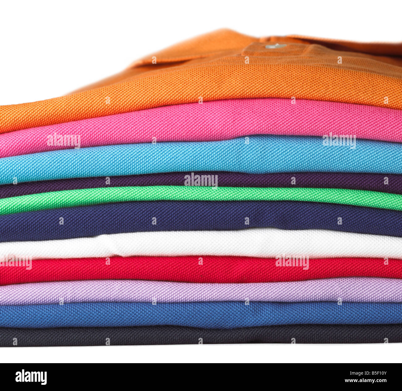 Stack of different coloured polo shirts Stock Photo - Alamy