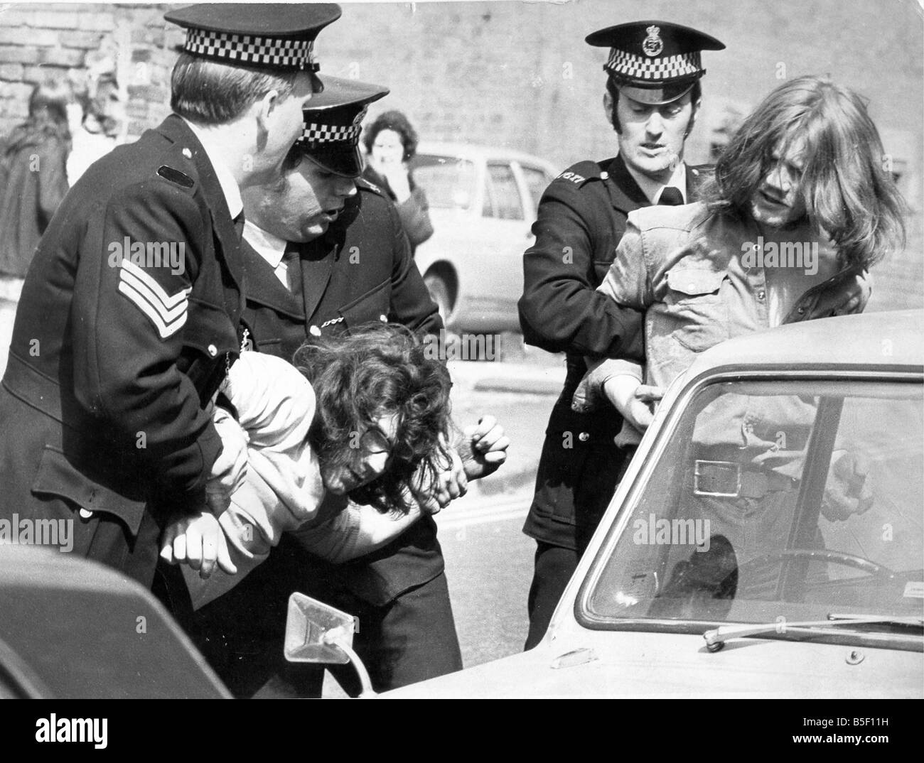 Two young men are arrested by police after a disturbance and bundled ...