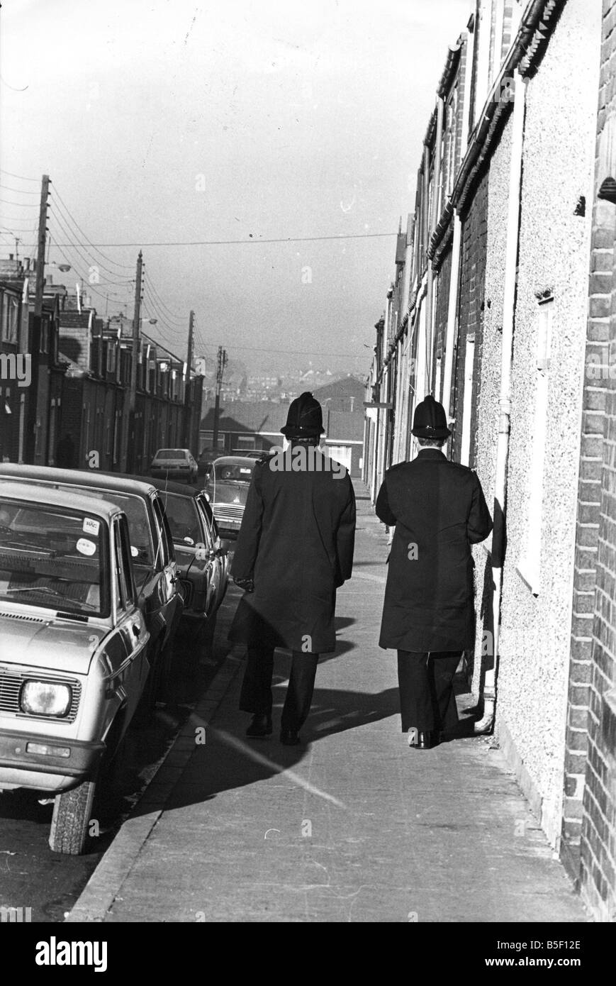Two police officers on the beat patrol the streets Stock Photo - Alamy