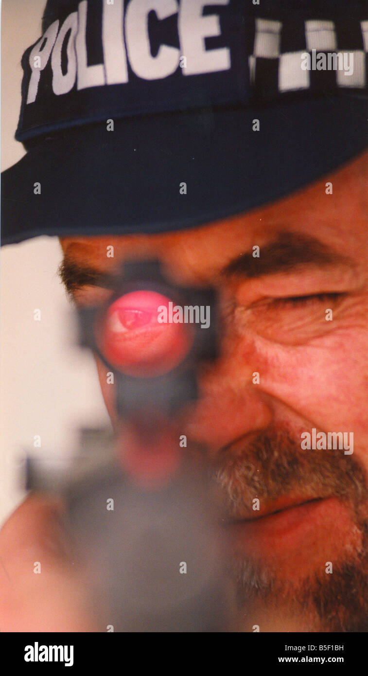 A police marksman aims his gun Stock Photo - Alamy
