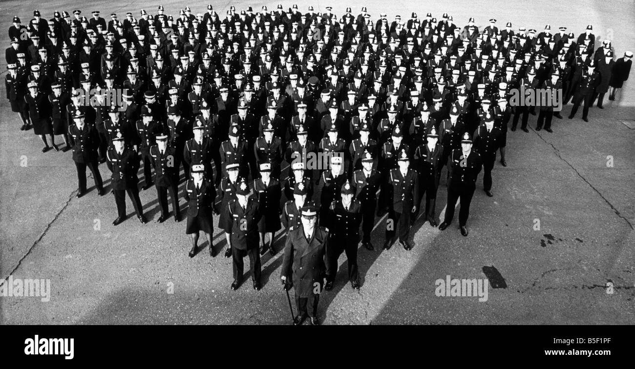 Forming the shape of an arrow a group of police officers ready for duty ...