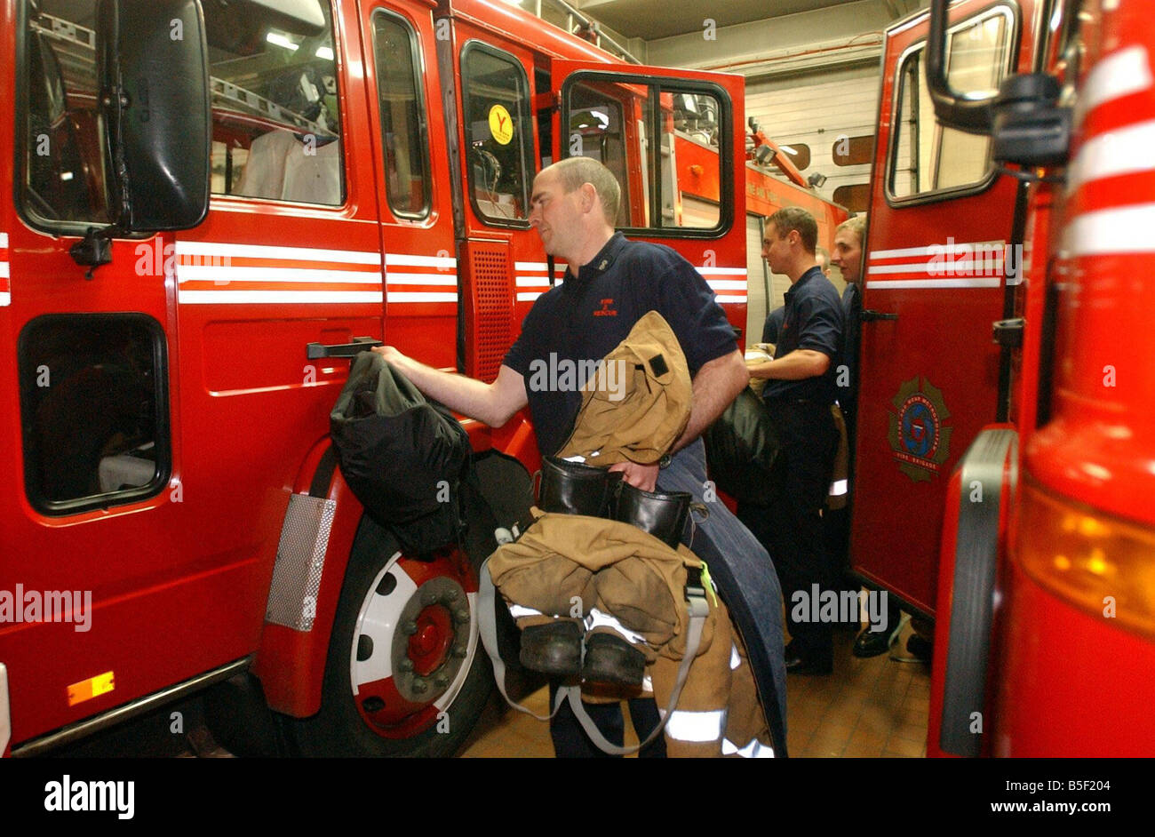 Firefighter Keith Bell prepares the fire engine for the next emergency ...