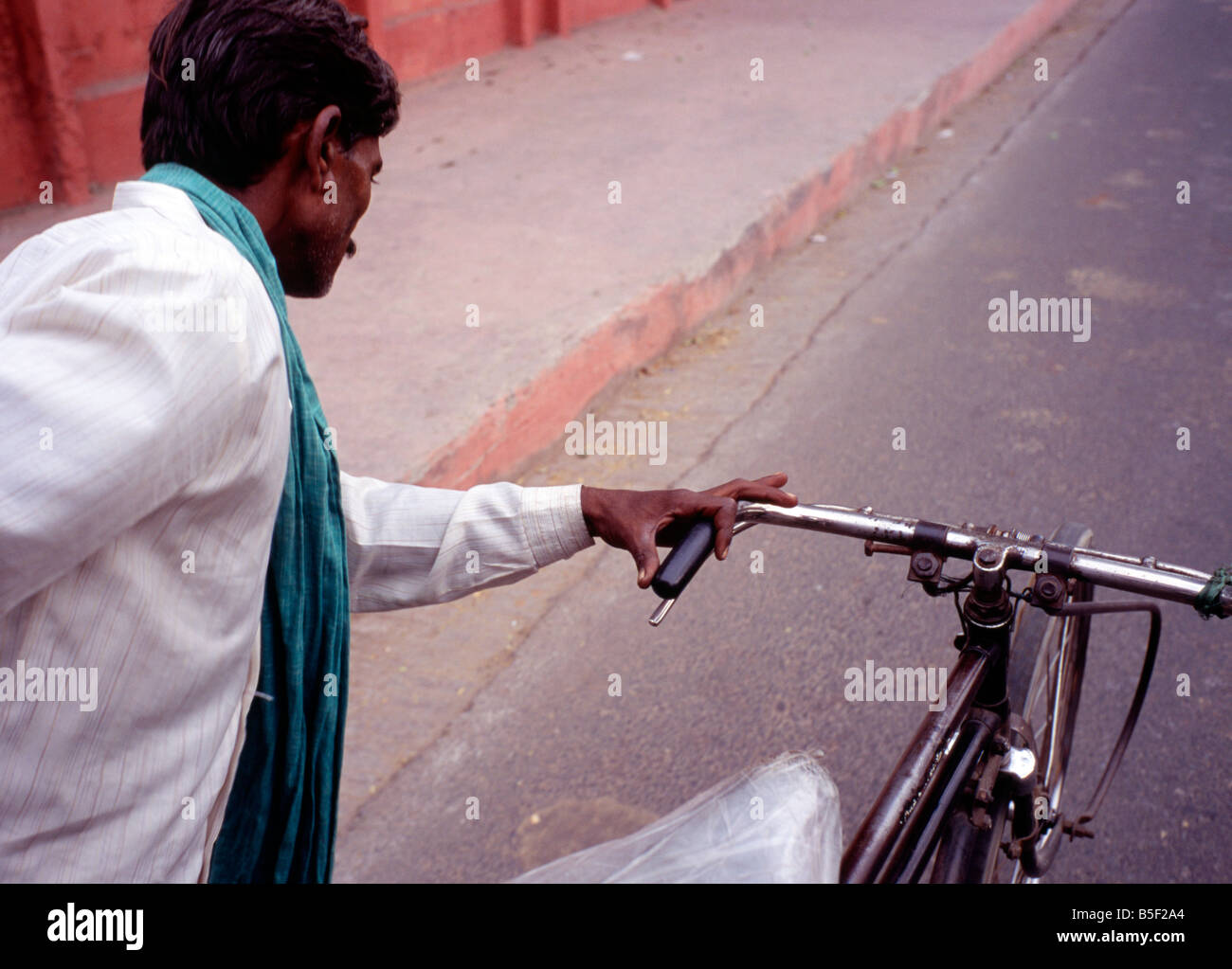 Indian man pushing bike Stock Photo - Alamy
