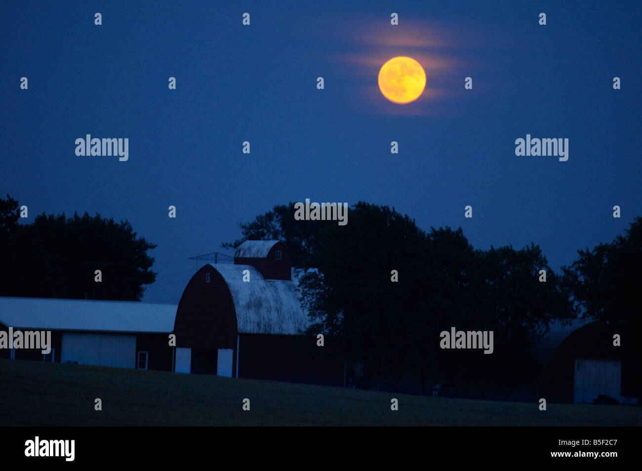 A full moon rises over a farm in the midwestern USA Stock Photo - Alamy