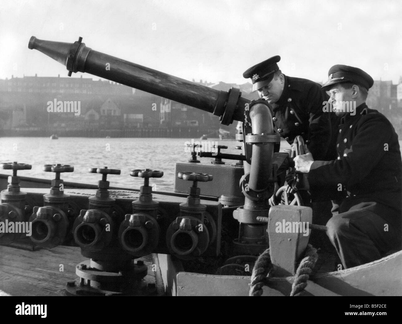 Some of the floating firemen demonstrating the boat s water gun Stock ...