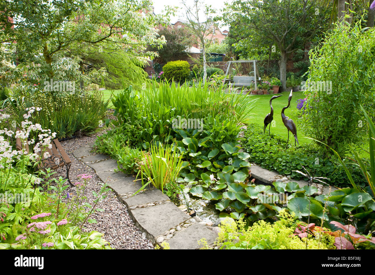 path alongside a garden pool Stock Photo - Alamy