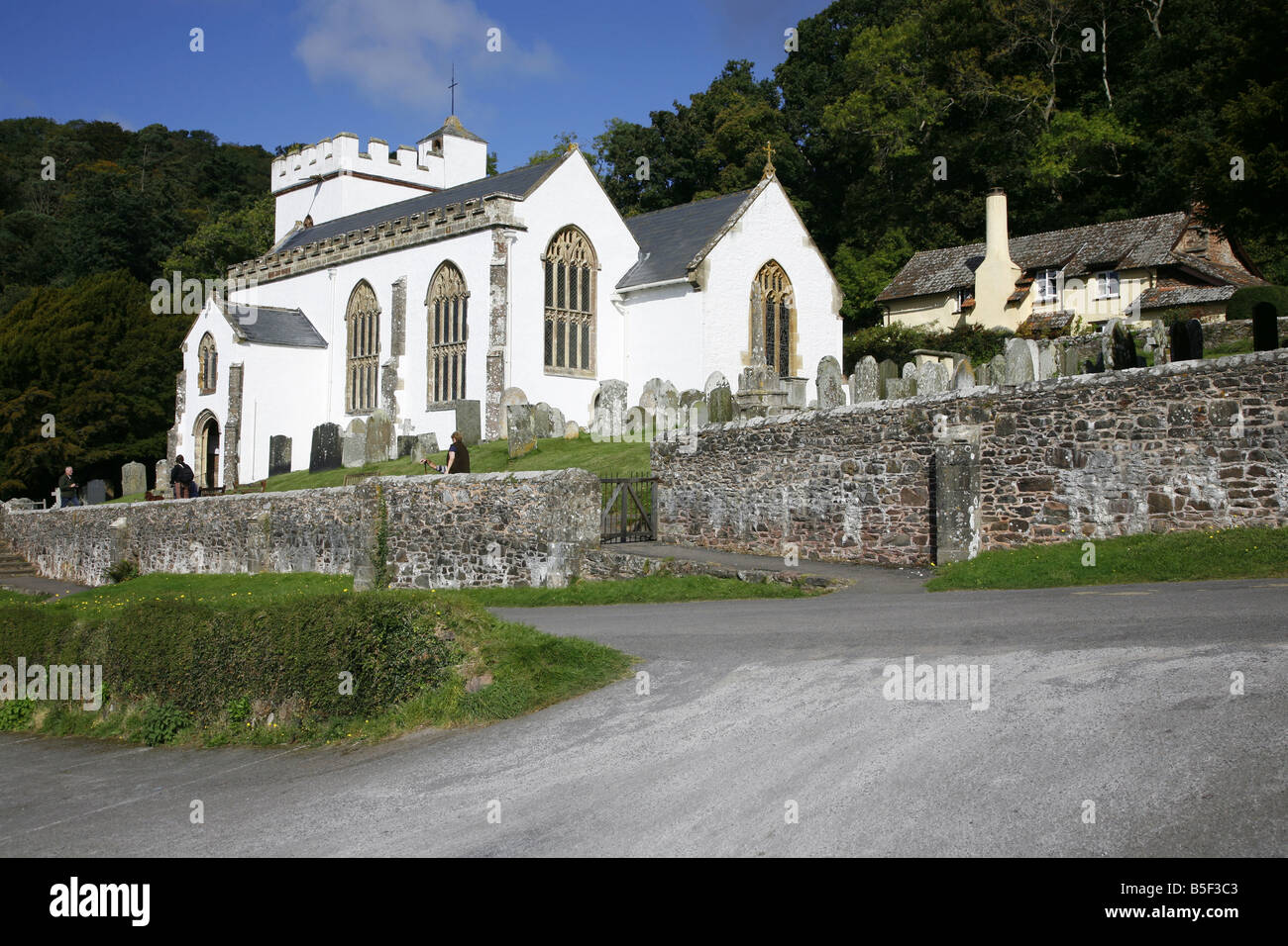 The white washed 15th century church of All Saints in the picturesque ...