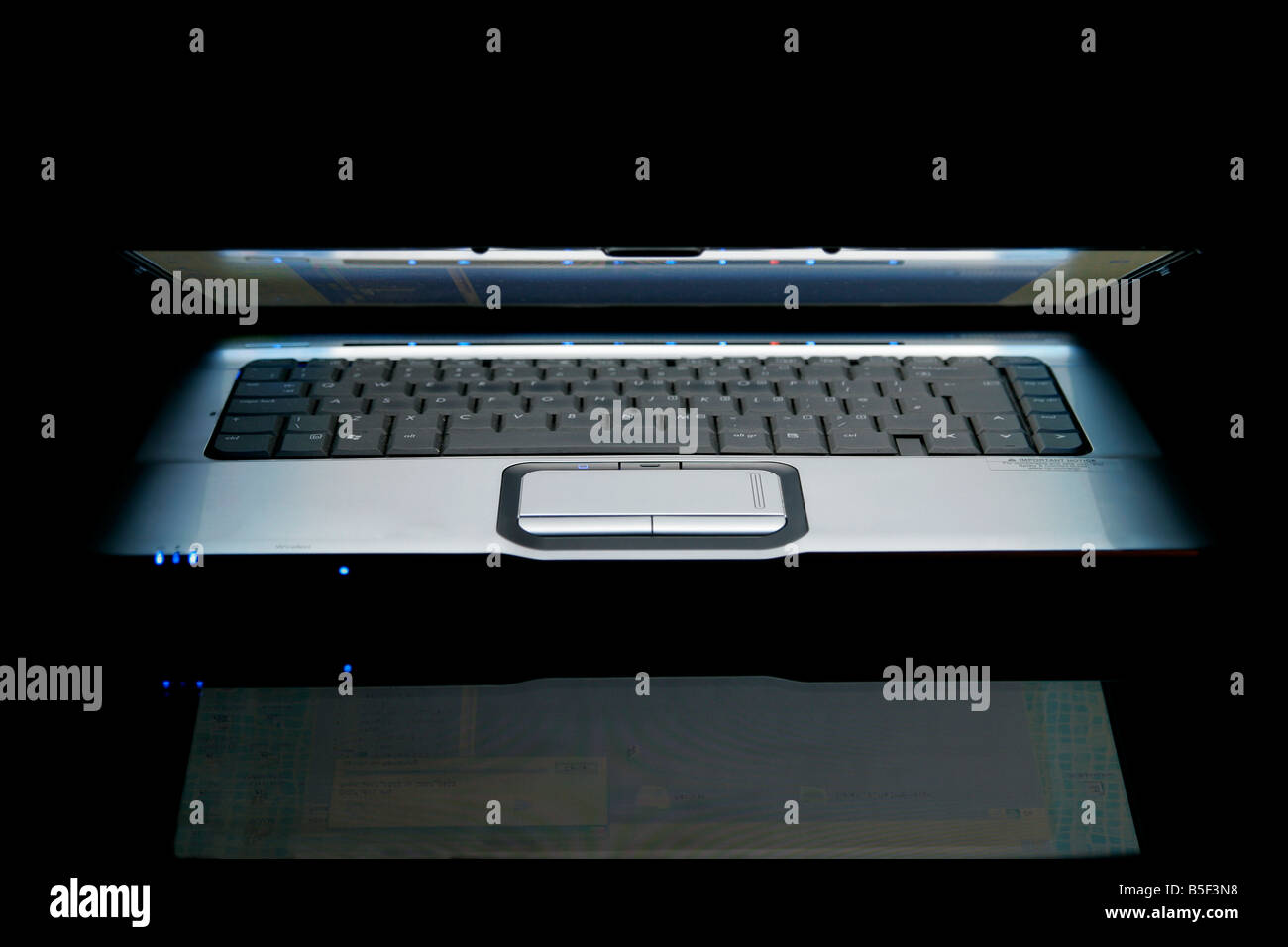 A laptop computer illuminated by its own screen light Stock Photo - Alamy
