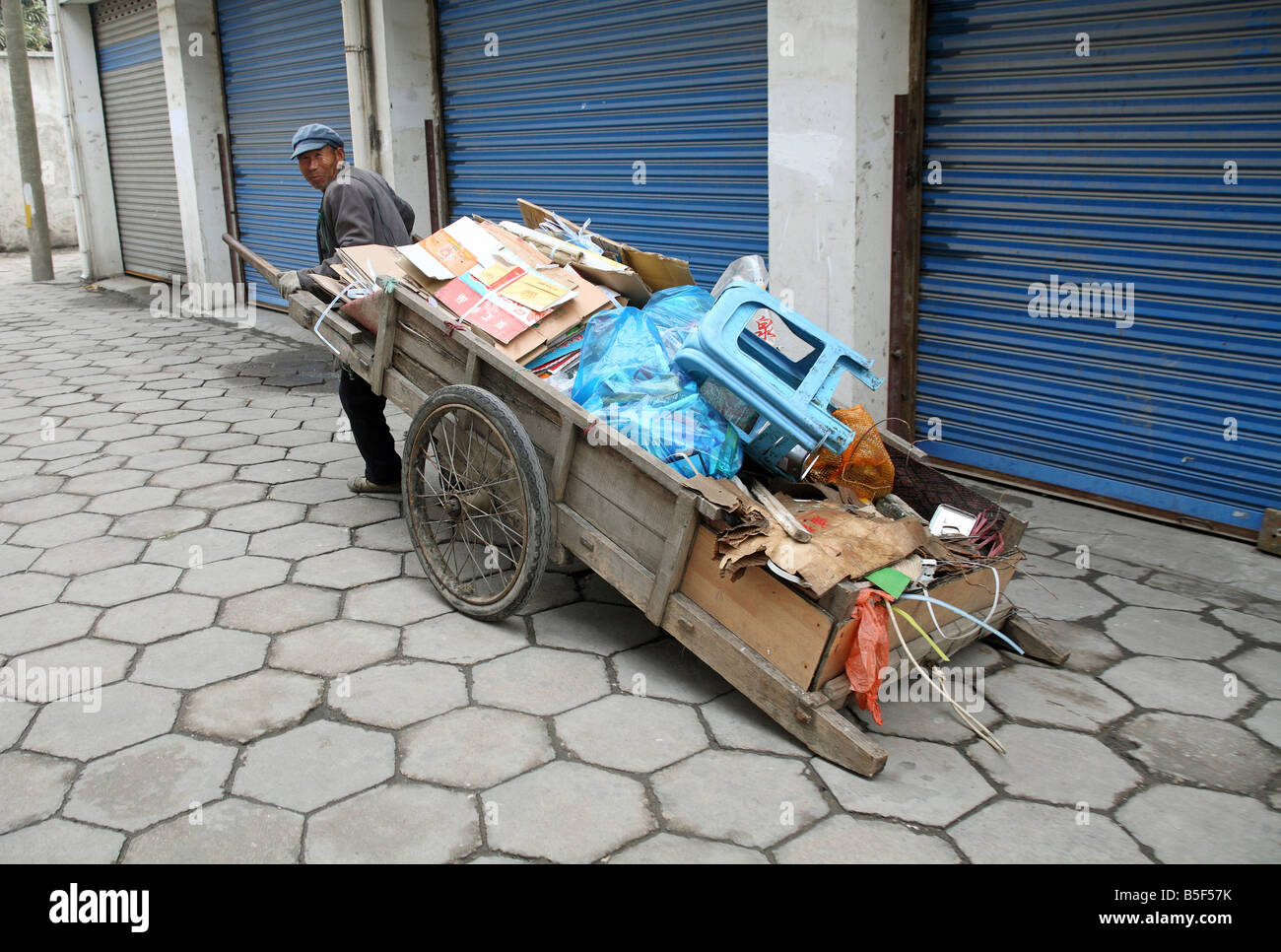 An Asian man pulling a loaded handcart, Suzhou, China Stock Photo - Alamy